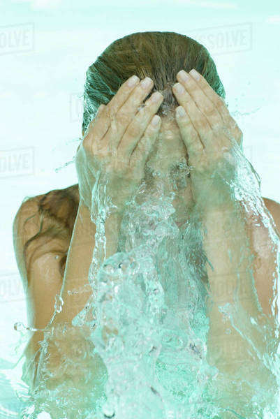 Young woman in pool, splashing face with water - Royalty-free Stock ...