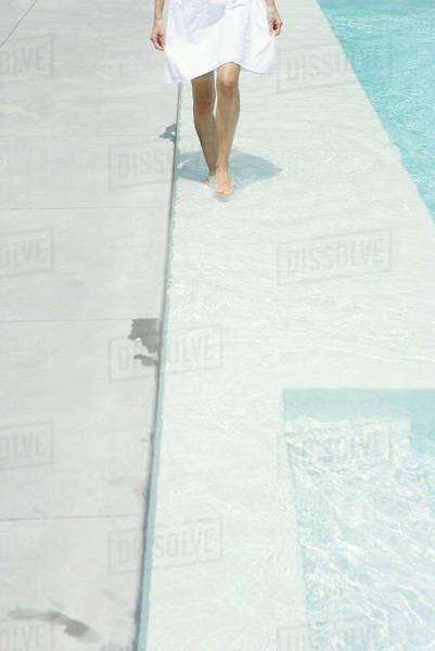 Woman walking on shallow swimming pool ledge, cropped view - Stock ...