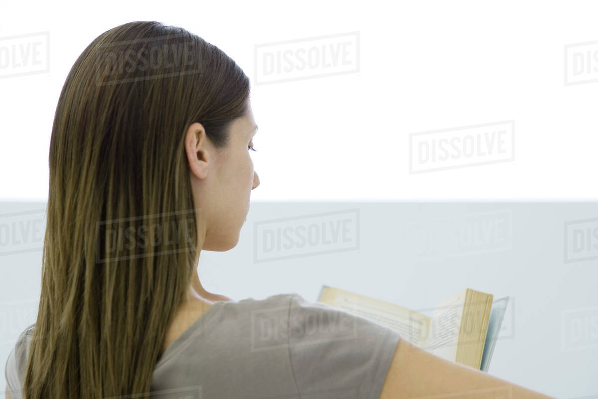 Woman reading book, rear view - Royalty-free Stock Photo | Dissolve