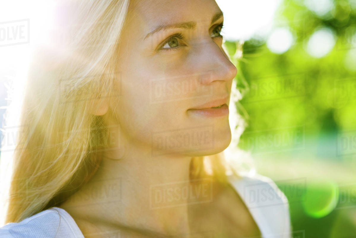 Young woman in sunlight, portrait - Royalty-free Stock Photo | Dissolve