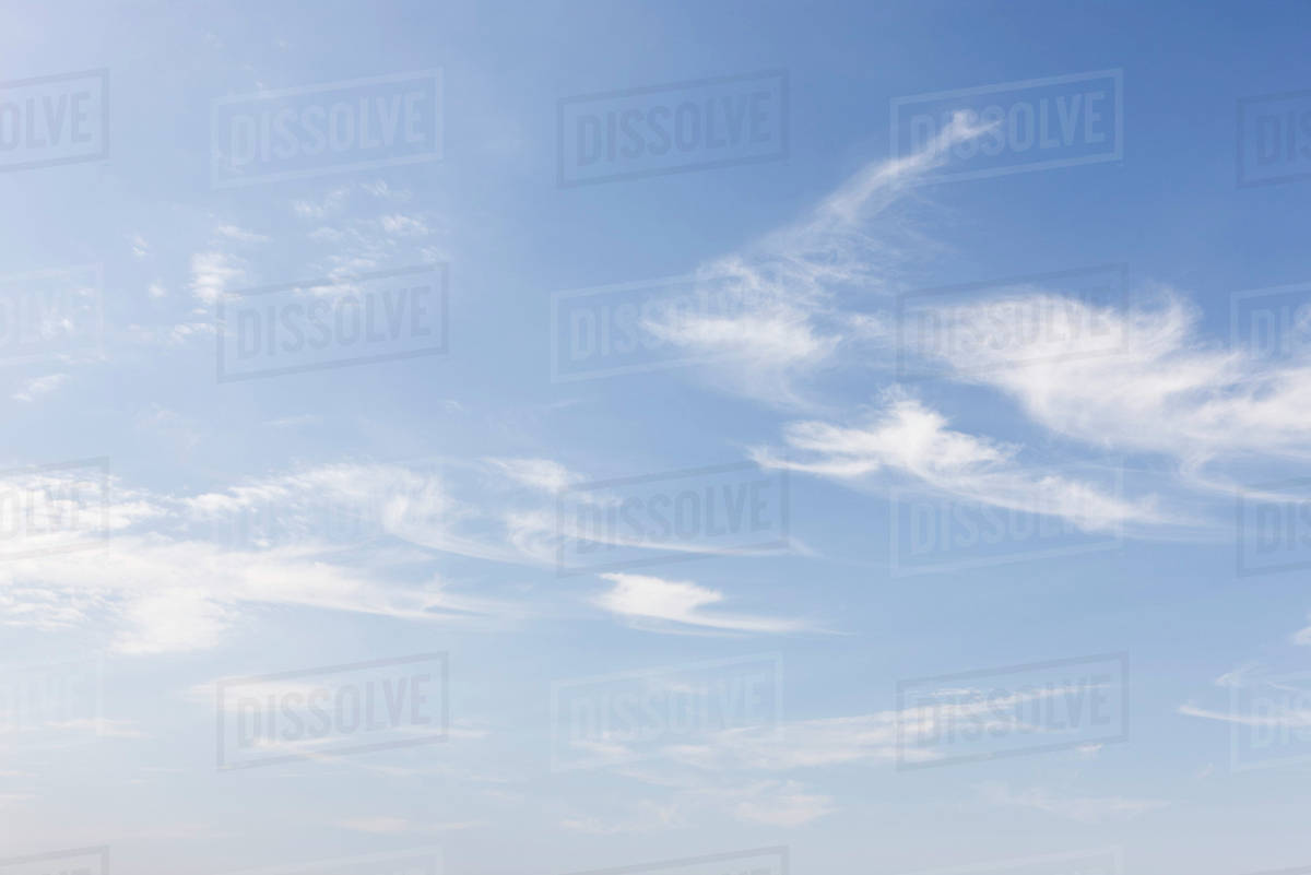 Wispy clouds in blue sky - Royalty-free Stock Photo | Dissolve