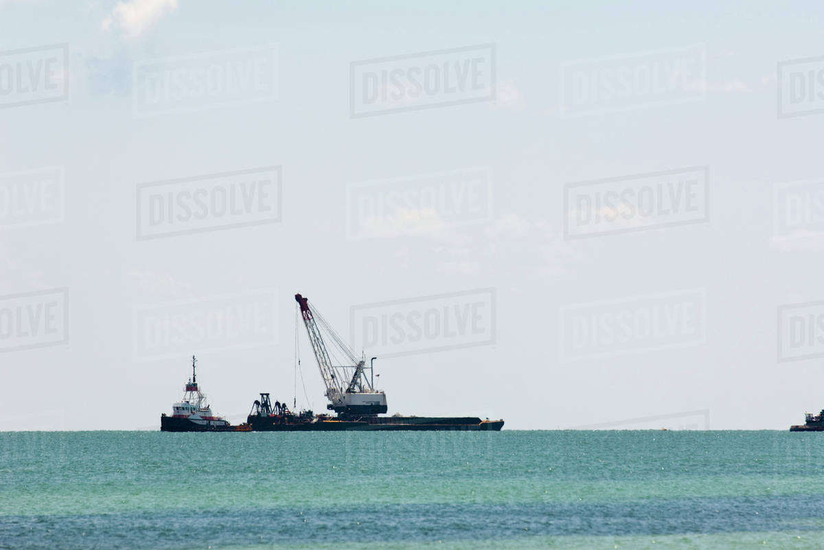 Tugboat pulling barge - Royalty-free Stock Photo | Dissolve