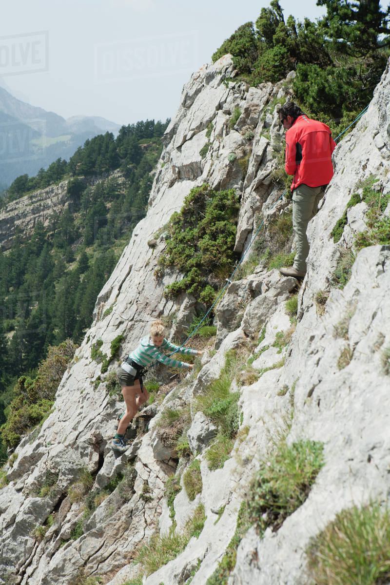 Hikers climbing on rock - Stock Photo - Dissolve