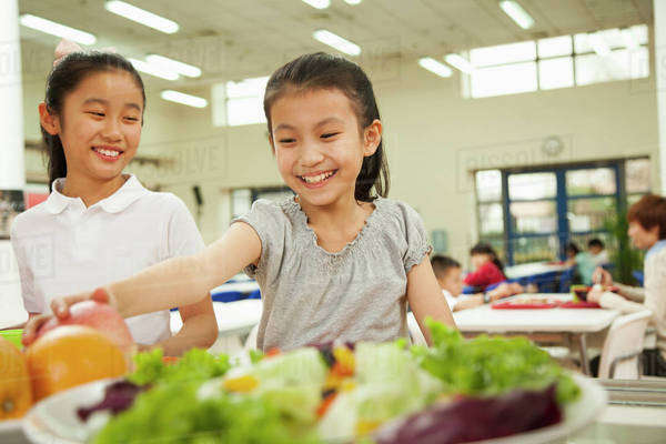 Students reaching for healthy food in school cafeteria - Stock Photo ...