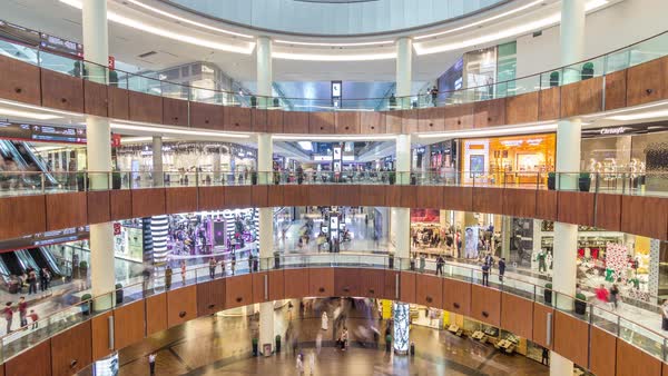 Inside the Dubai Mall timelapse top view. People walking on few levels ...