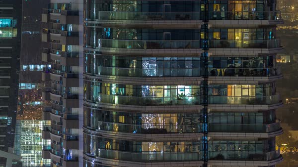 Windows of the multi-storey building of glass and steel lighting inside ...
