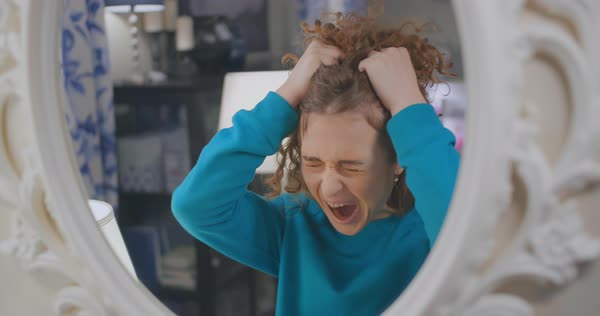 Beautiful young depressed woman screaming in mirror - 4K Royalty-free ...
