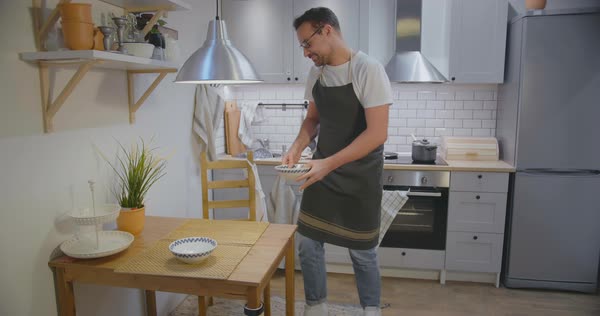 Handsome man setting table for two - 4K Royalty-free Stock Video ...