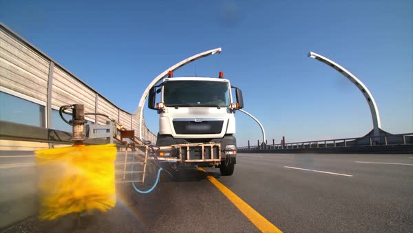 City road cleaning machine clearing road barriers in modern highway ...
