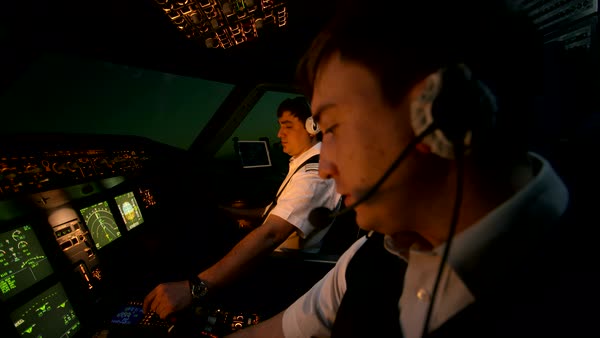 Pilot and co-pilot inside aircraft cockpit flying plane - 4K Royalty ...