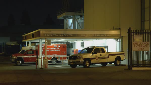 Locked-off shot of ambulance entrance of a hospital at night in Los ...