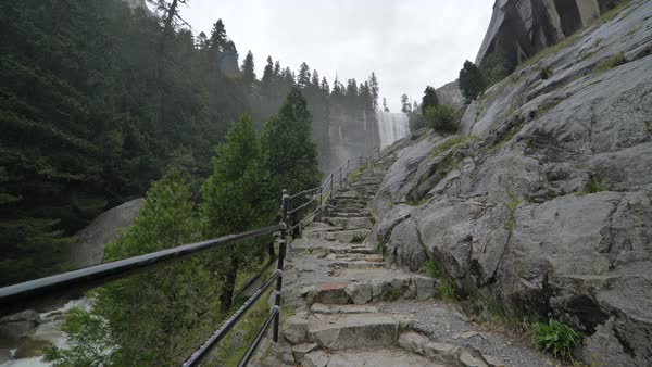 Handrail along the rocky stairs of Mist Trail waterfall hike, Yosemite ...