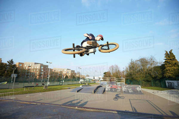 Mid-air action shot of bmx rider in park - Royalty-free Stock Photo ...