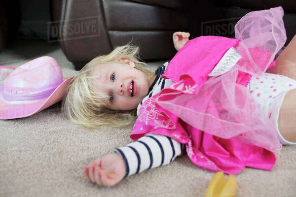 Portrait of young girl playing dressing up game - Stock Photo - Dissolve