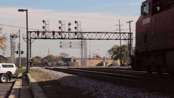 Locked off shot of a train moving on railways at level crossing - HD ...