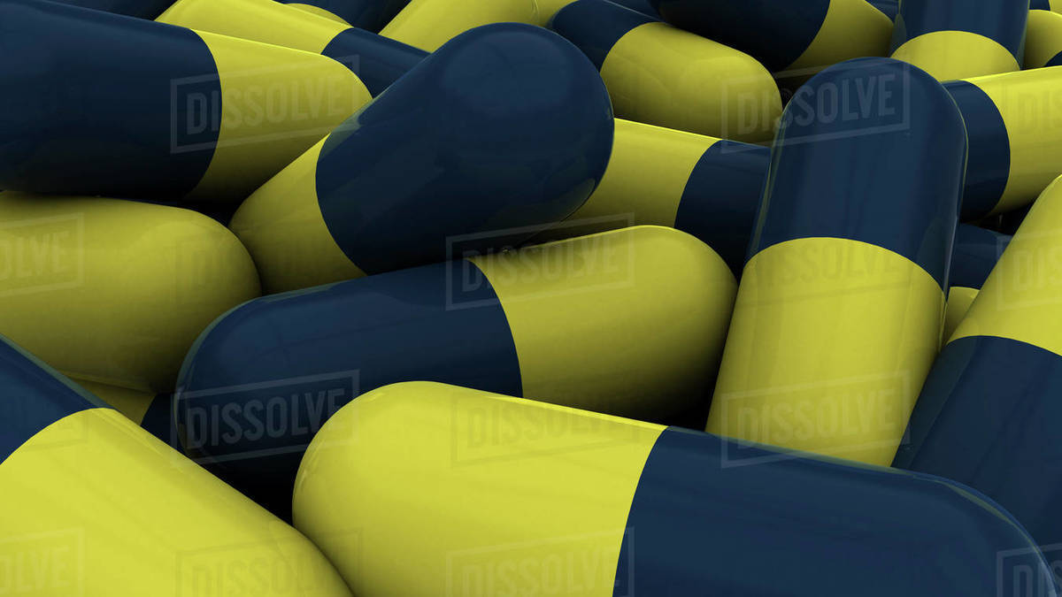 Pile of blue and yellow medication capsules. - Royalty-free Stock Photo ...