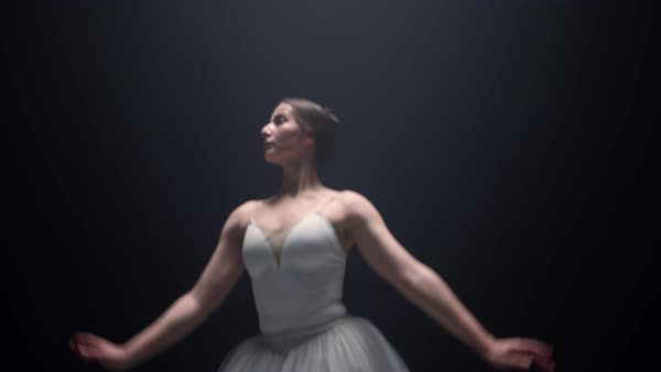 Pretty ballet dancer performing on stage. Flexible ballerina dancing ...