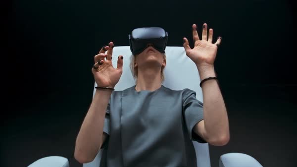 Haptic sensors hands man sitting armchair zoom out. Person exploring ...