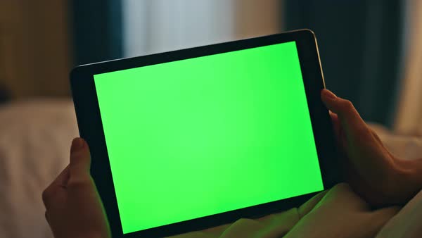 Closeup green screen tablet in hands home. Night person watch chromakey ...