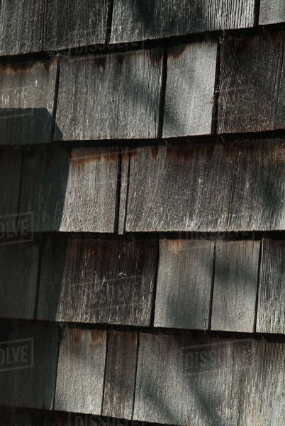 Close up of overlapping wall-hung timber tiles. - Stock Photo - Dissolve