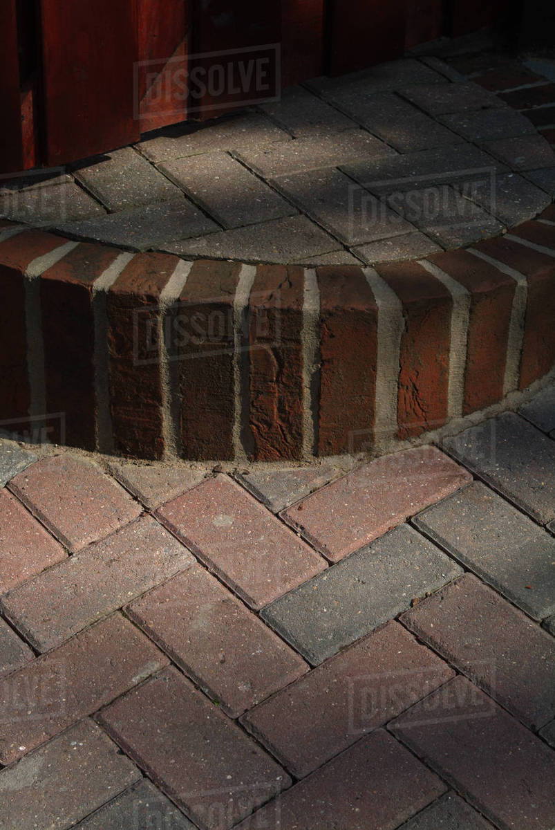 Close up of red clay herring bone pattern pavings with curved step ...