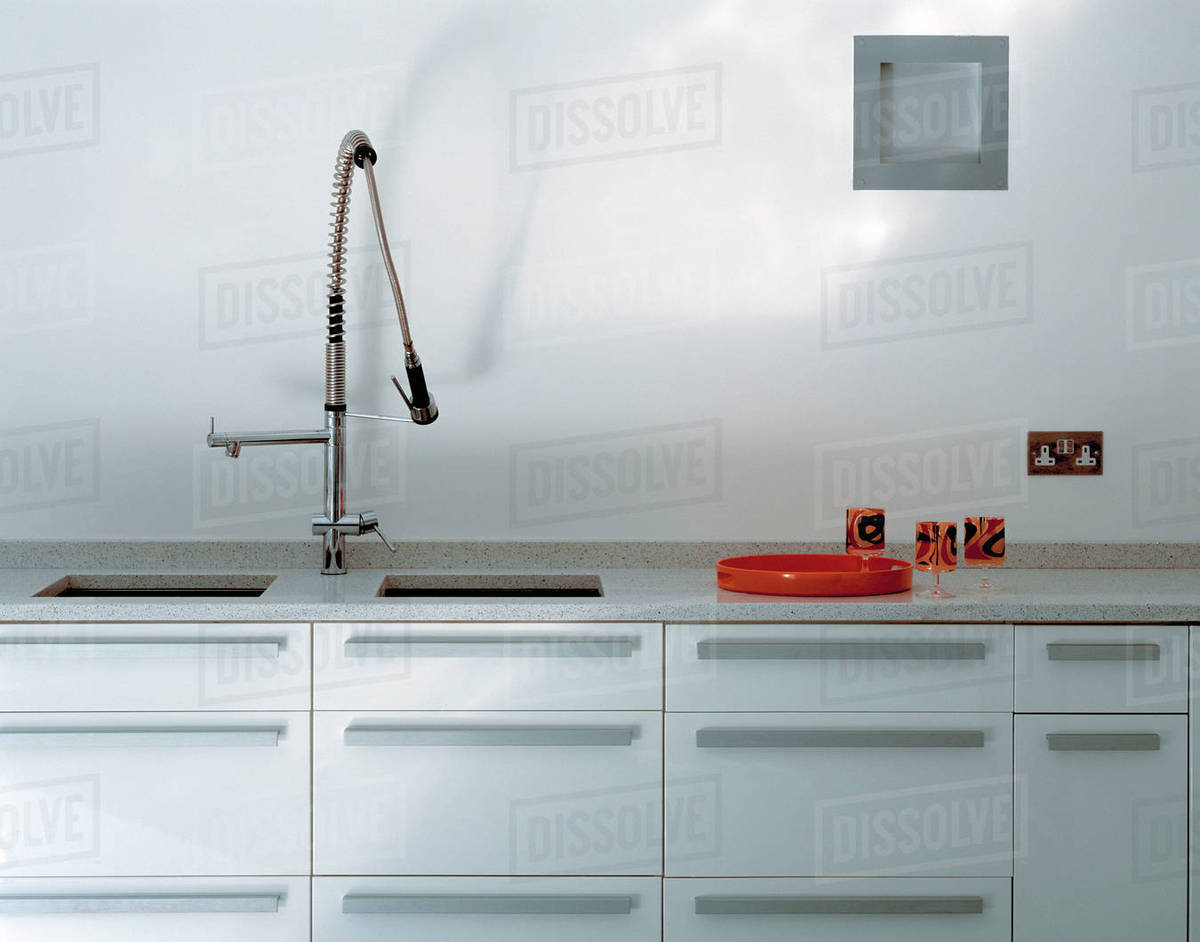 White marble topped kitchen with double sink and extending tap - Stock ...