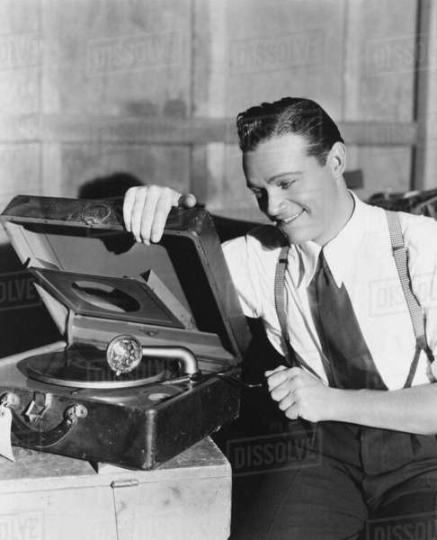 Man listening to record player - Royalty-free Stock Photo | Dissolve