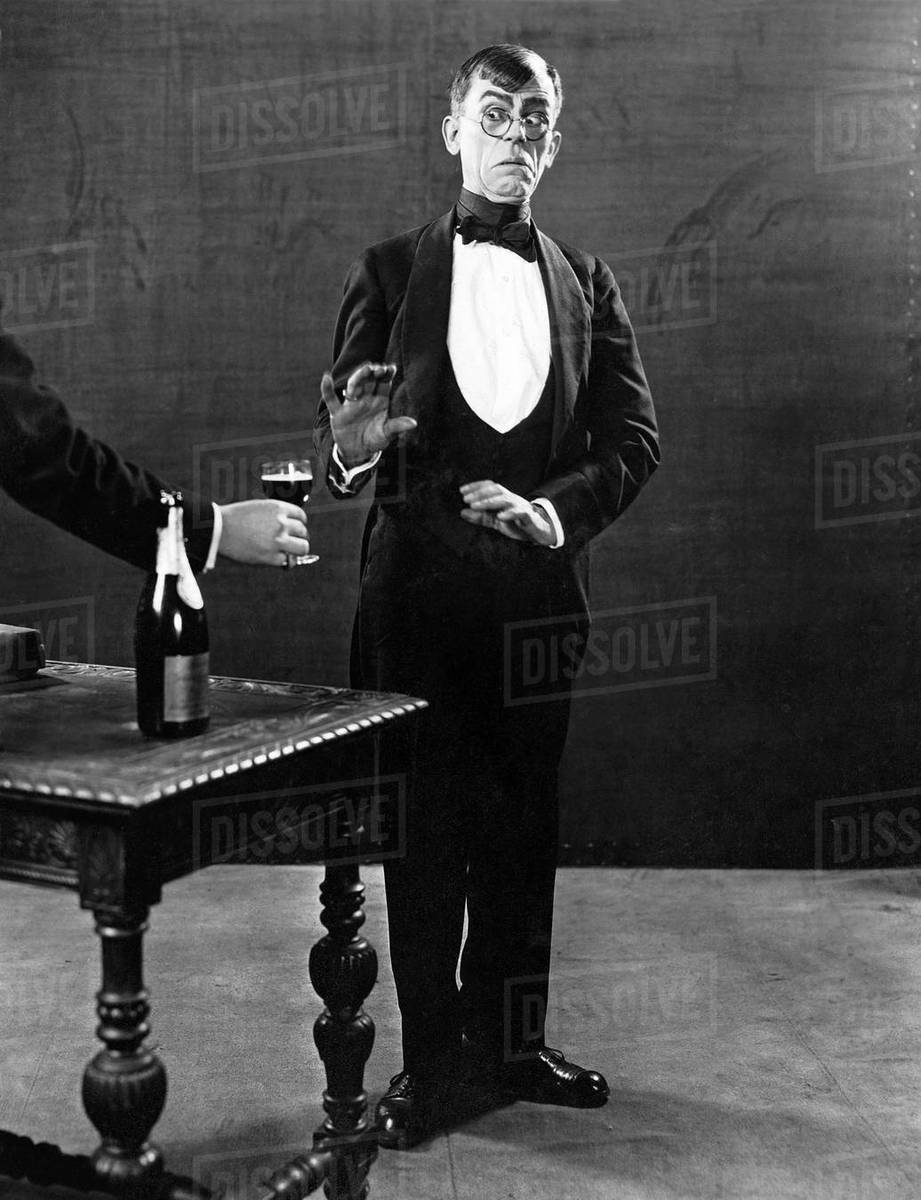 Man recoiling from beverage - Royalty-free Stock Photo | Dissolve