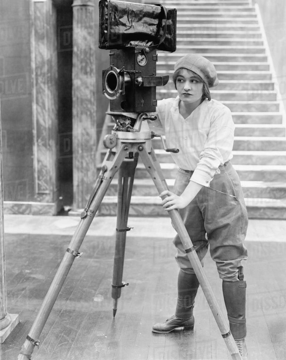 Woman operating movie camera - Royalty-free Stock Photo | Dissolve