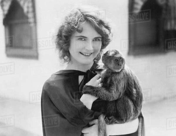 Woman holding a pet monkey in her arms - Royalty-free Stock Photo ...