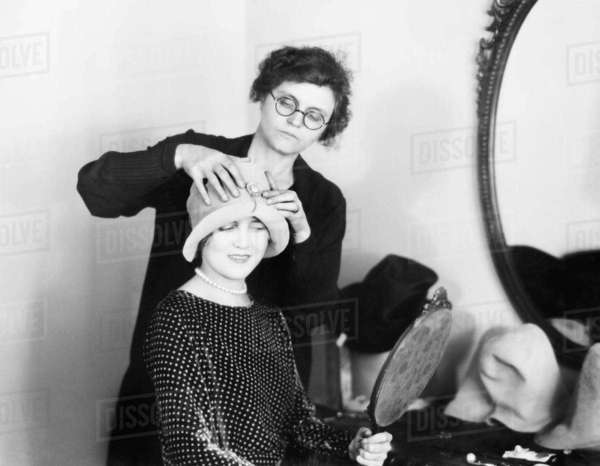 A hat maker fitting a hat on a customer - Royalty-free Stock Photo ...