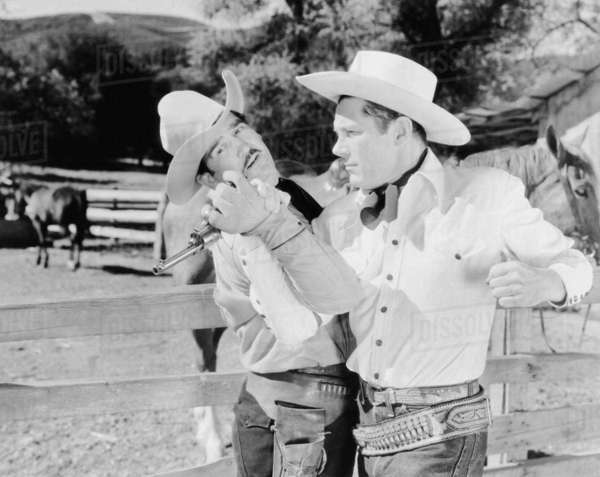 Two cowboys fighting with each other - Stock Photo - Dissolve