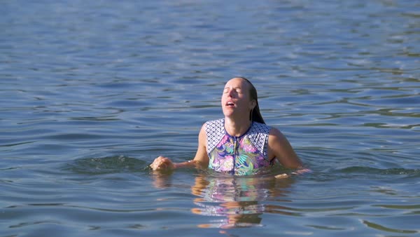 Slow motion shot of a woman emerging from water - Stock Video Footage ...