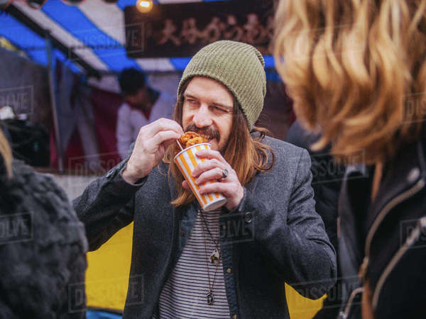 Man eating street food in market, Kyoto, Japan - Royalty-free Stock ...