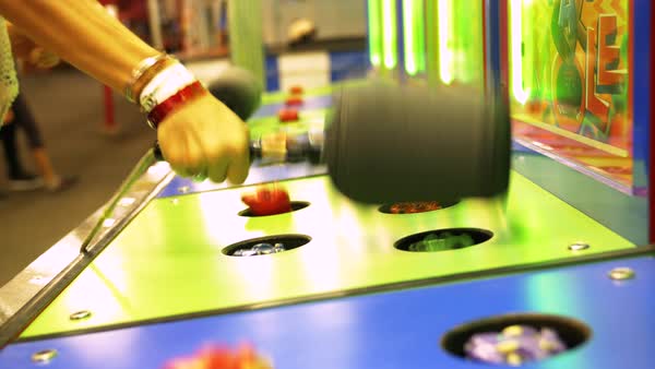 Hand-held shot of a person playing a whack-a-mole game - Stock Video ...