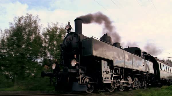 Old historical steam engine locomotive riding in slow motion on ...
