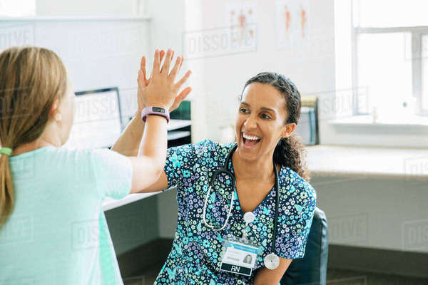 Nurse high-fiving girl - Royalty-free Stock Photo | Dissolve