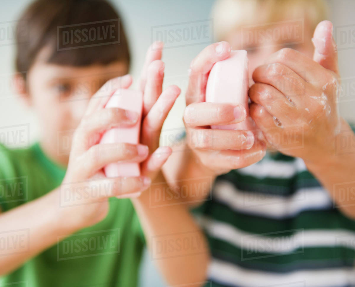 Boys washing their hands with soap - Stock Photo - Dissolve