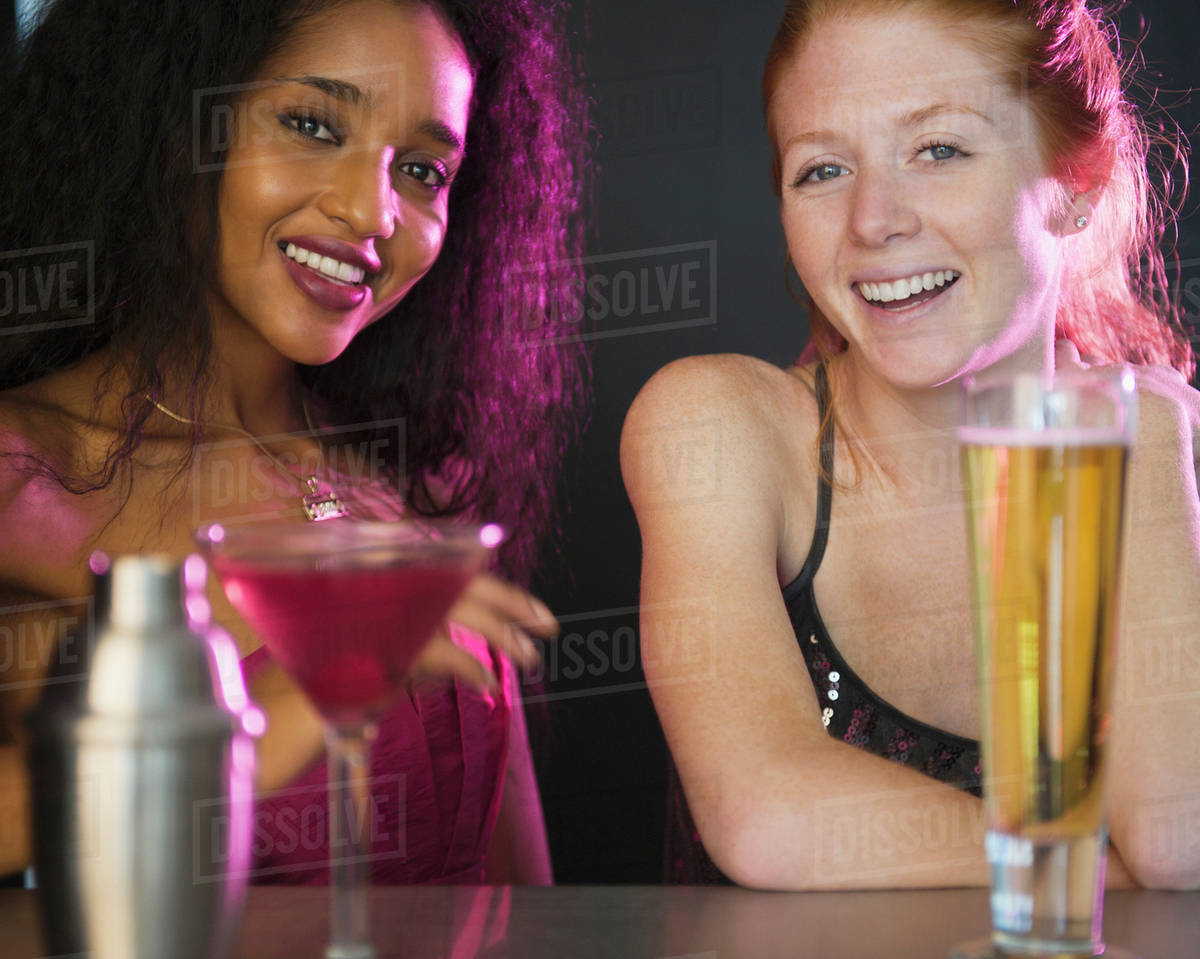 Smiling friends drinking cocktails - Royalty-free Stock Photo | Dissolve