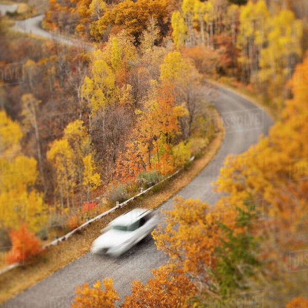 Car driving along road through autumn leaves - Royalty-free Stock Photo ...