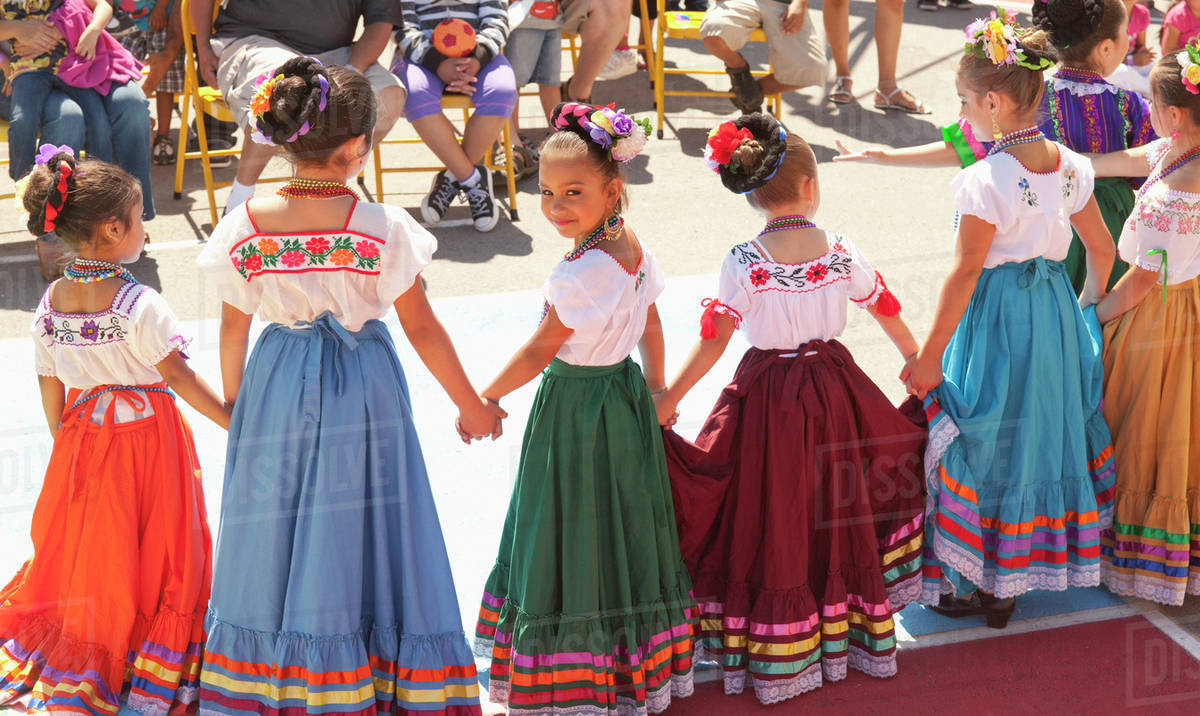Hispanic girls dancing in costumes - Stock Photo - Dissolve