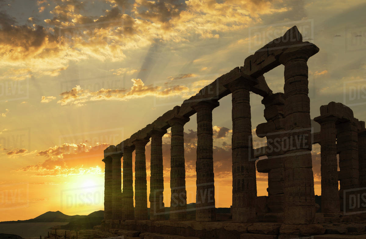 Temple of Poseidon ruins under sunset sky, Cap Sunion, Greece - Royalty ...