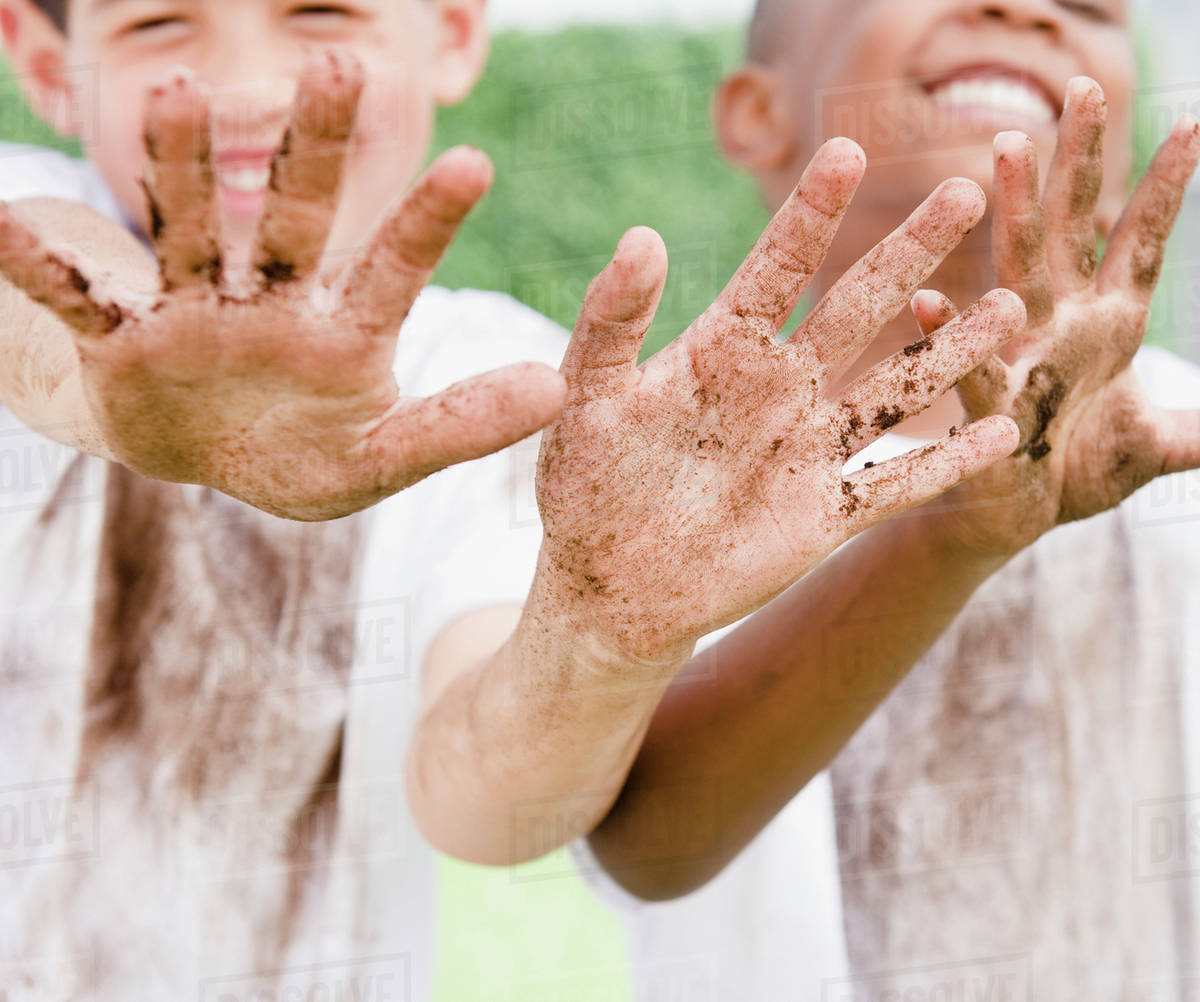 Boys displaying their messy hands - Stock Photo - Dissolve