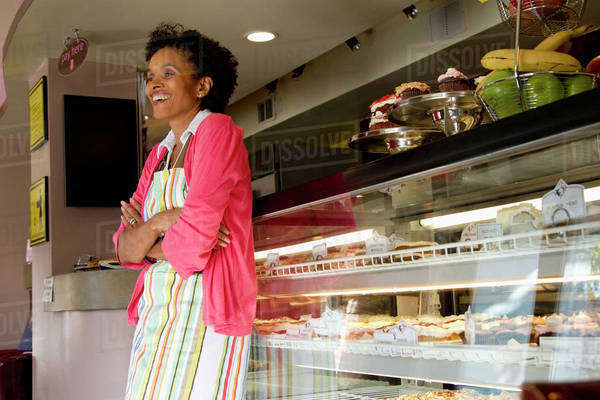 Bakery owner standing in shop - Royalty-free Stock Photo | Dissolve
