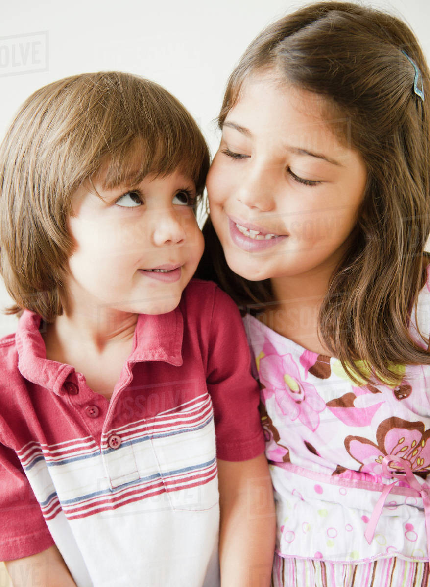 Hispanic brother and sister hugging - Stock Photo - Dissolve