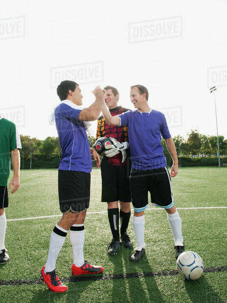 Soccer players cheering on soccer field - Royalty-free Stock Photo ...