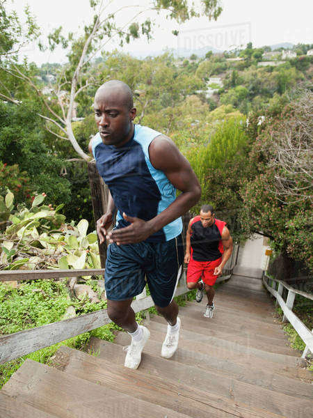 Men running up stairs for exercise - Stock Photo - Dissolve