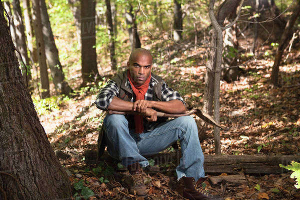 African American man sitting in woods - Royalty-free Stock Photo | Dissolve