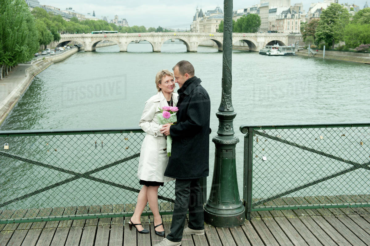 Caucasian couple talking on bridge - Royalty-free Stock Photo | Dissolve