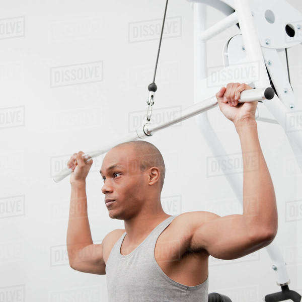 African man using weight machine in health club - Royalty-free Stock ...